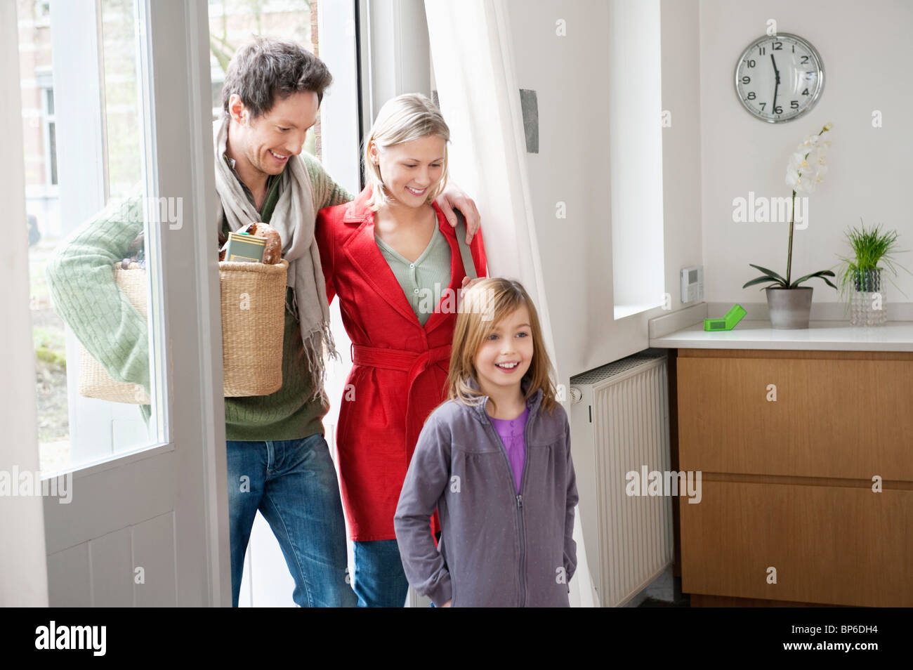 Family entering the house Stock Photo - Alamy