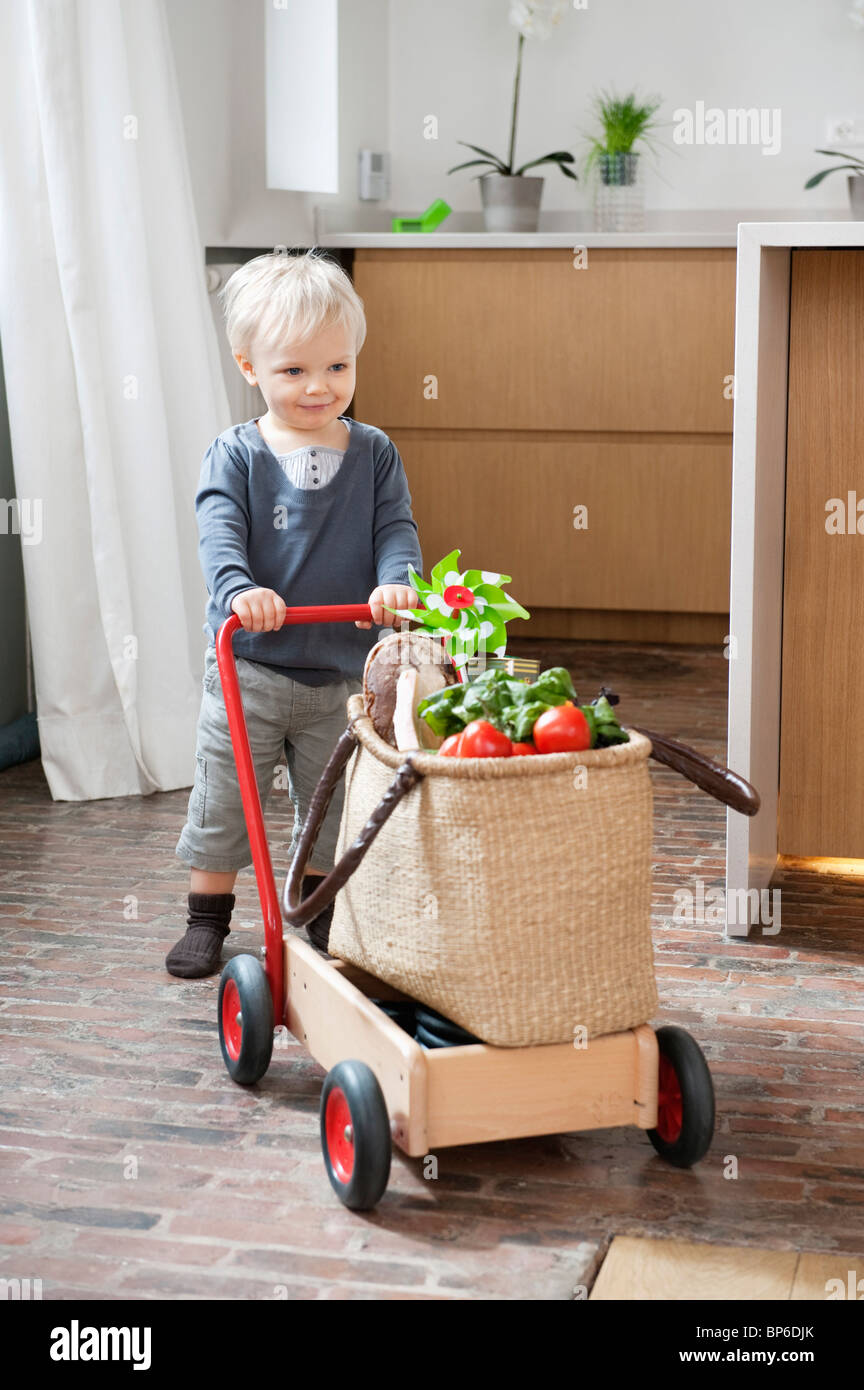 Boy pushing shopping cart hi-res stock photography and images - Alamy