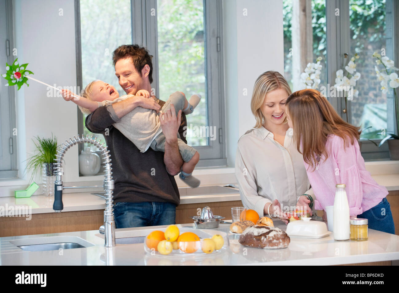 Family in the kitchen Stock Photo - Alamy