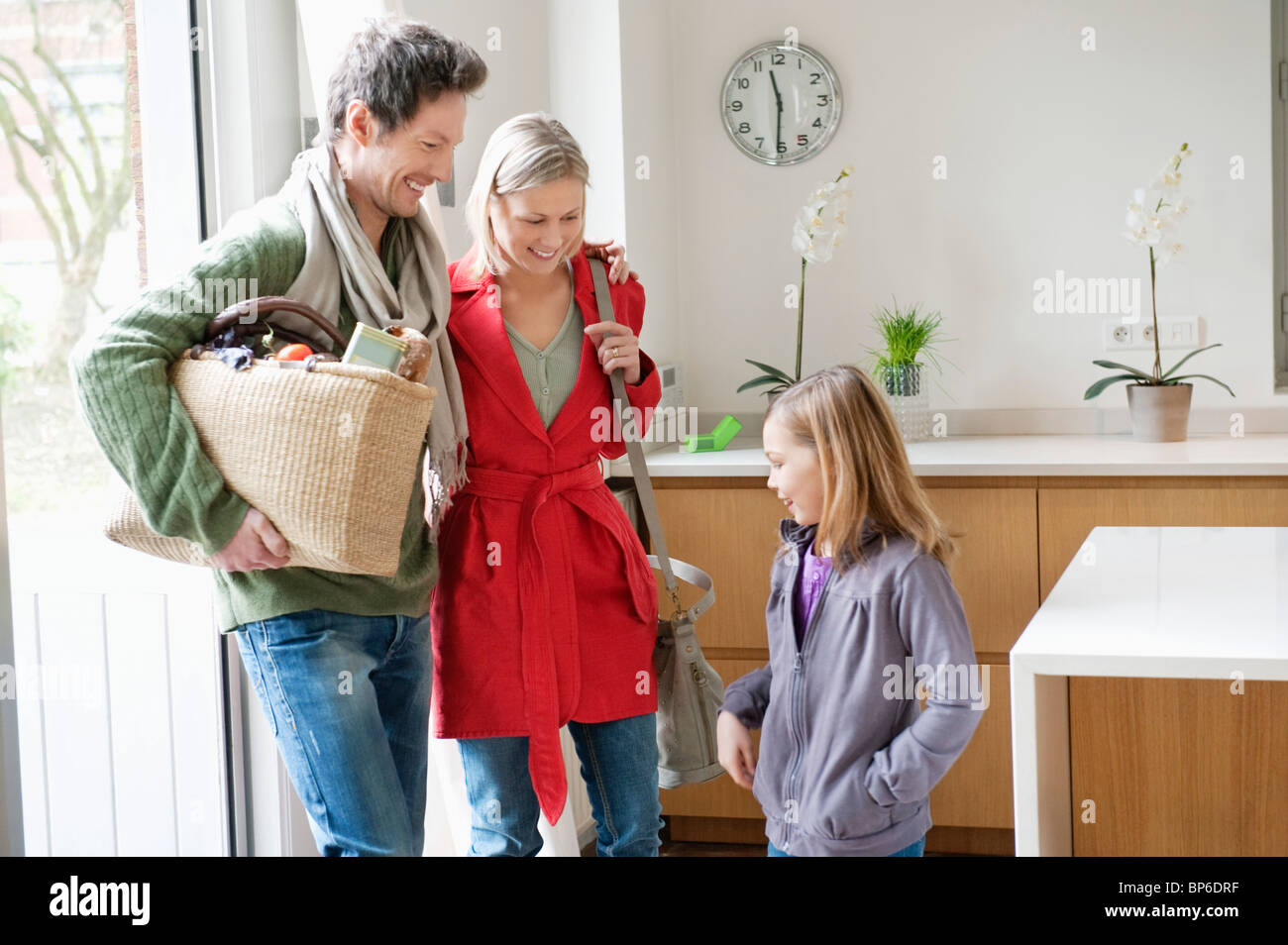 Family entering the house Stock Photo - Alamy
