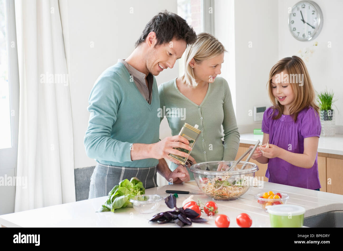 Family preparing food in the kitchen Stock Photo - Alamy