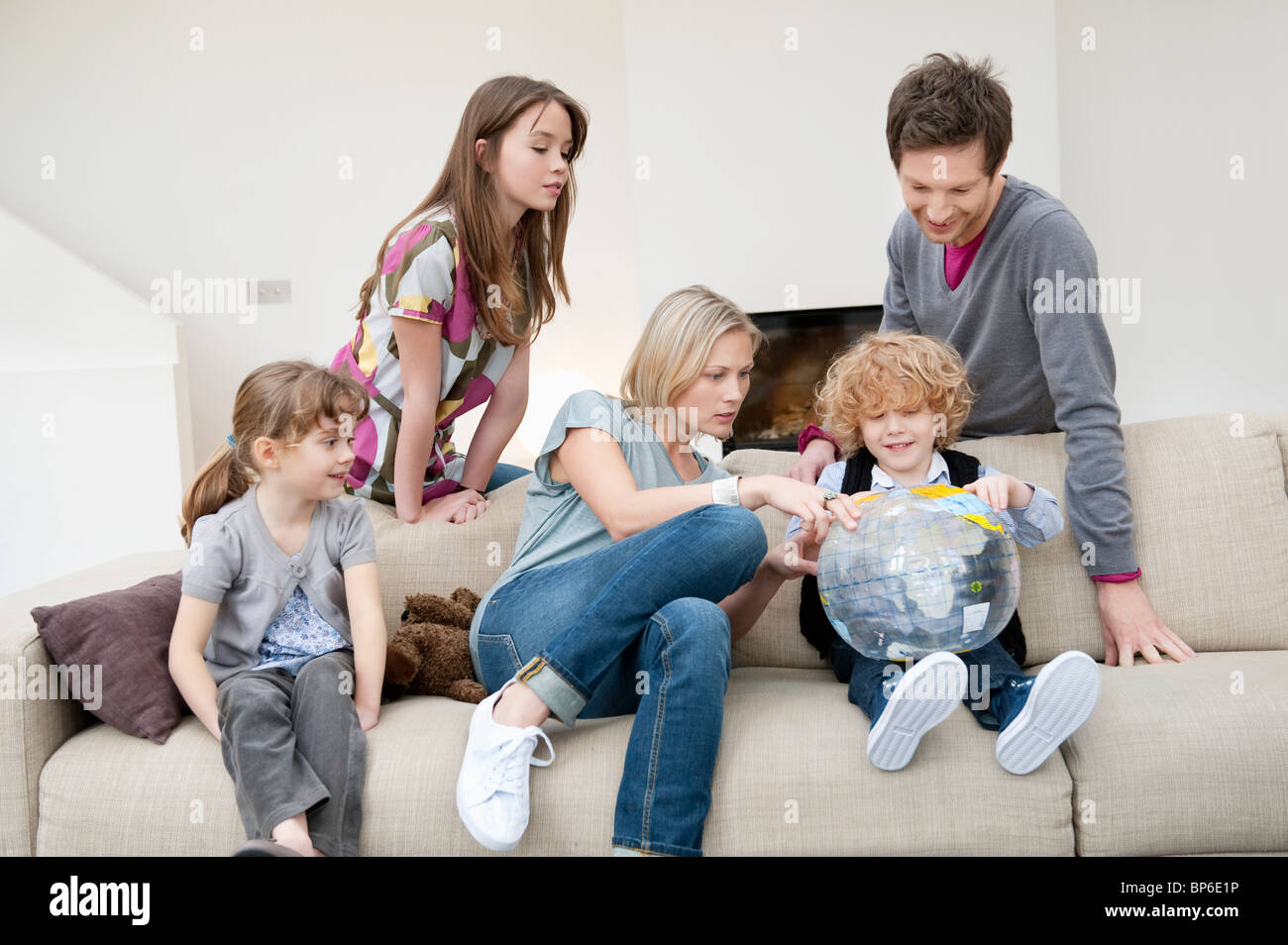Family in a living room Stock Photo - Alamy