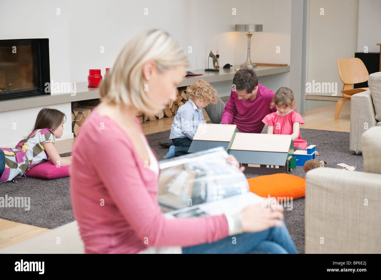 Family in a living room Stock Photo - Alamy