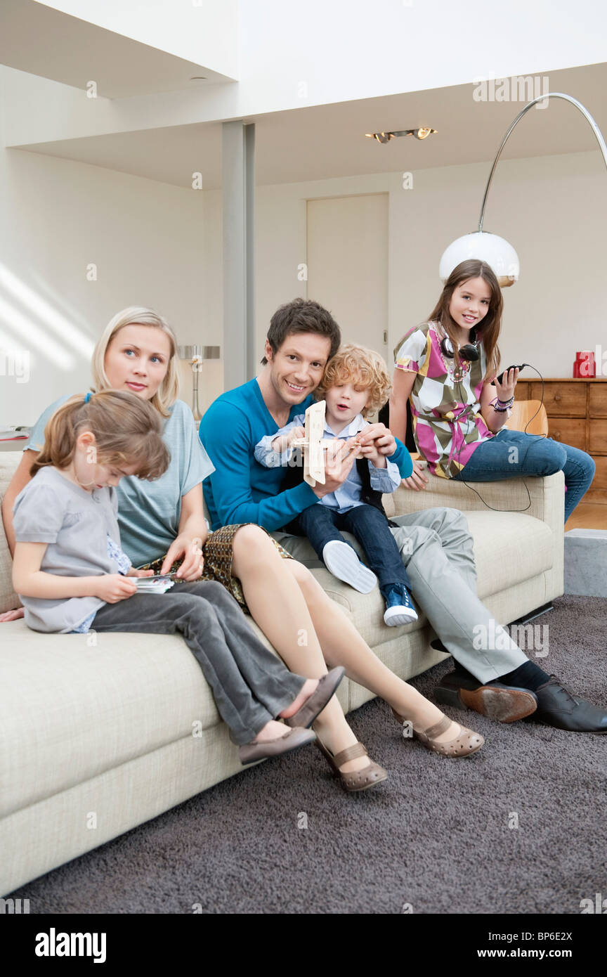 Family in a living room Stock Photo - Alamy