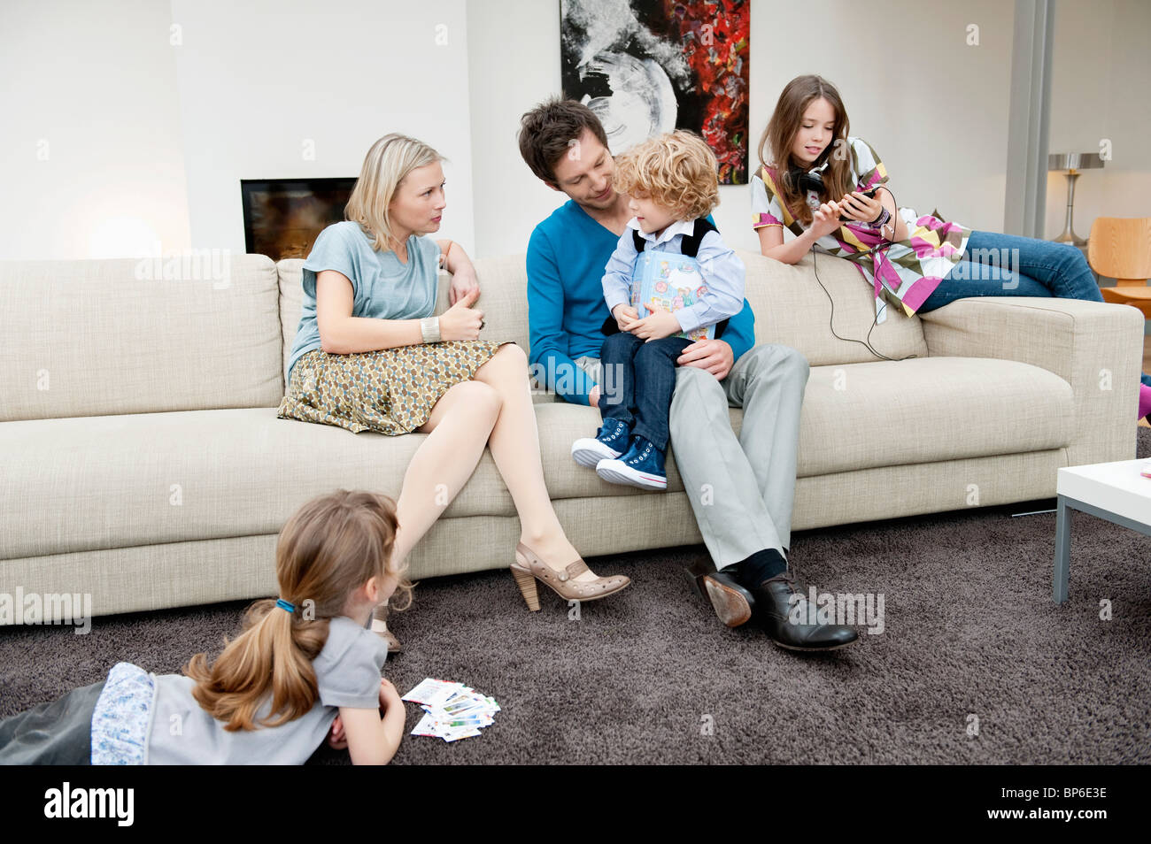 Family in a living room Stock Photo - Alamy