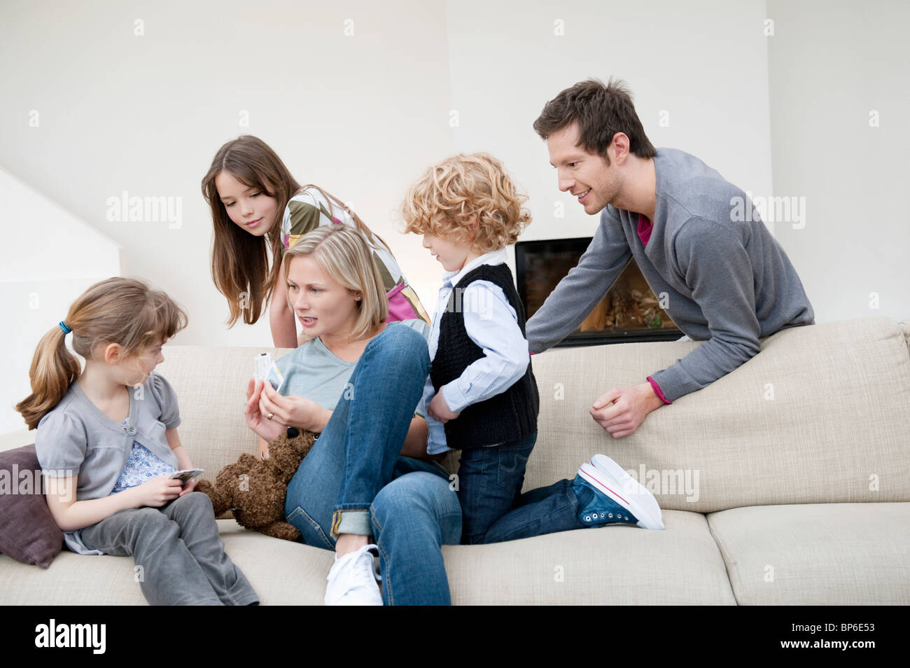 Family in a living room Stock Photo - Alamy