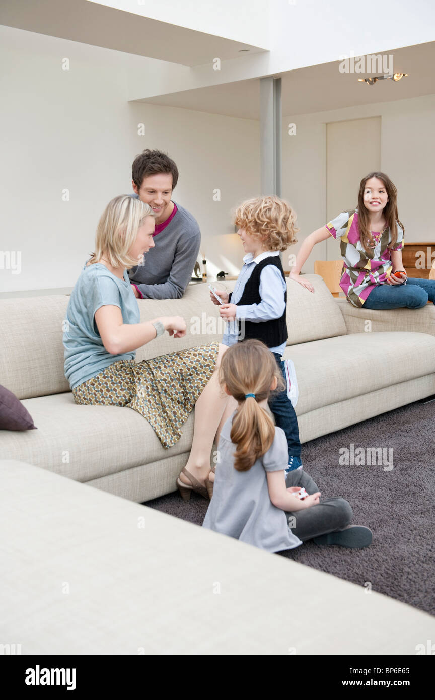 Family in a living room Stock Photo - Alamy