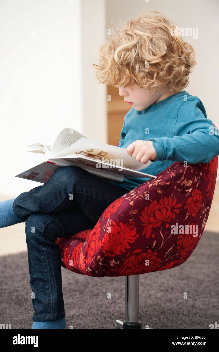 Boy reading a book Stock Photo - Alamy