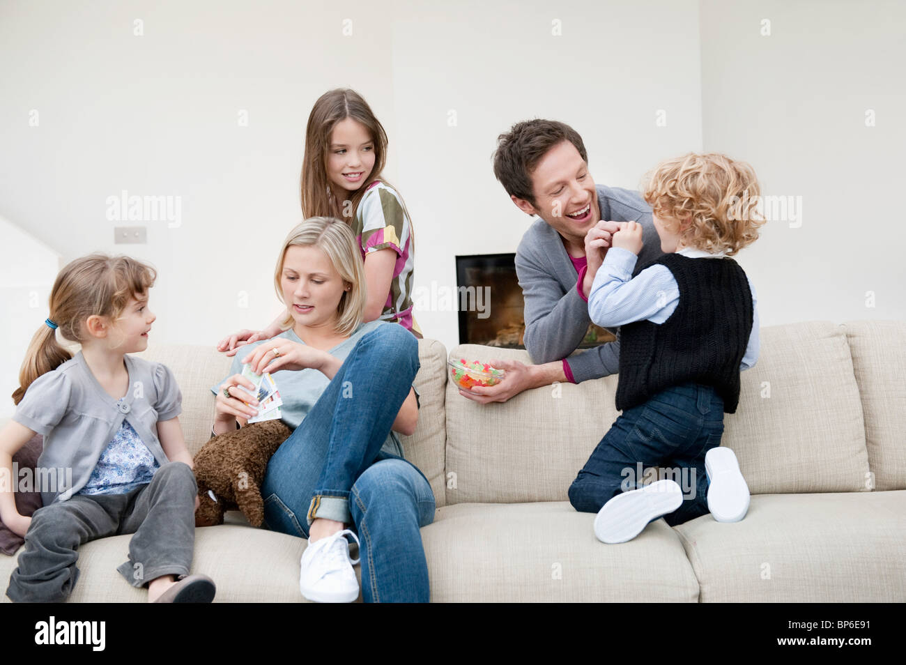 Family in a living room Stock Photo - Alamy