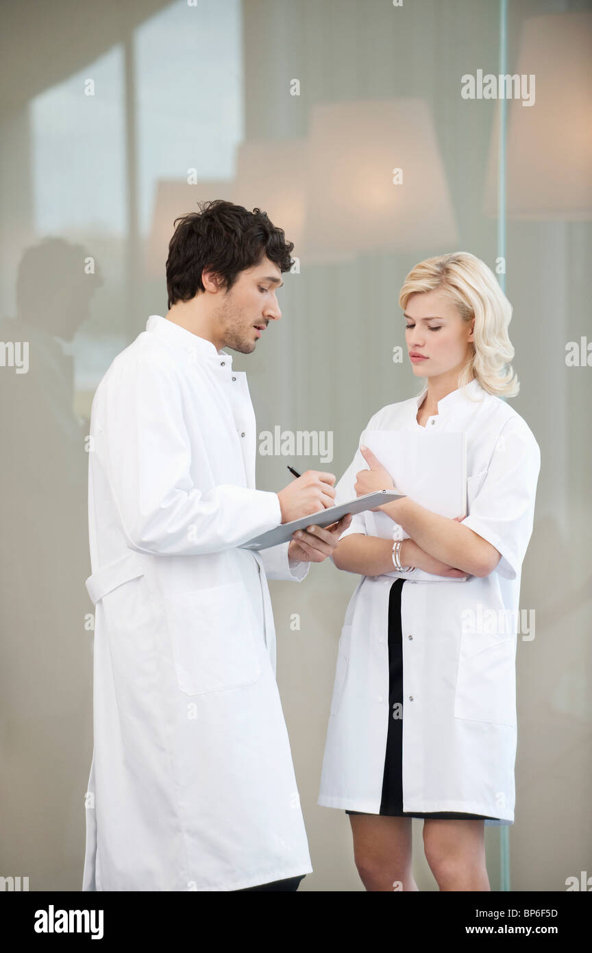 Doctors examining a medical report Stock Photo - Alamy