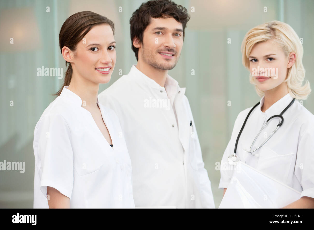 Portrait of three doctors smiling Stock Photo - Alamy