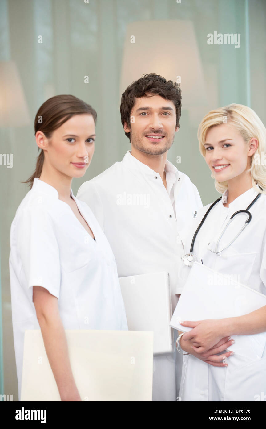 Portrait of three doctors smiling Stock Photo - Alamy