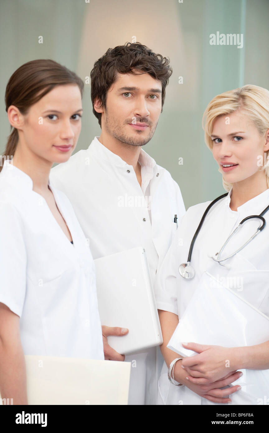 Portrait of three doctors smiling Stock Photo - Alamy