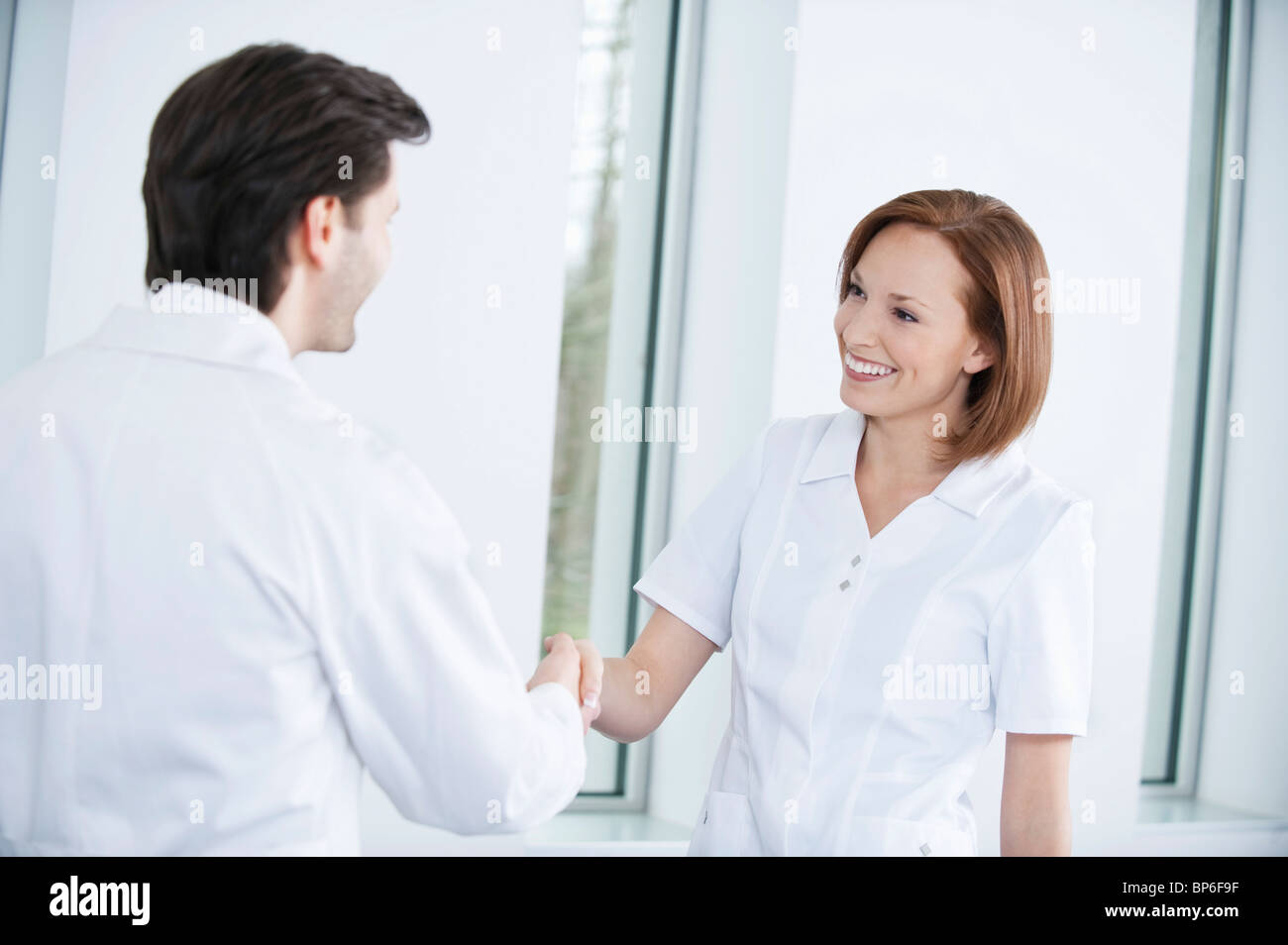 Two doctors shaking hands Stock Photo - Alamy