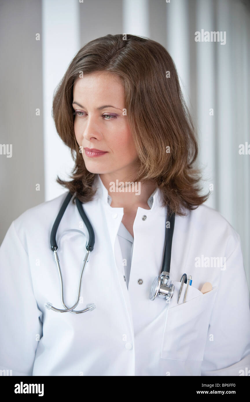 Female doctor thinking Stock Photo - Alamy