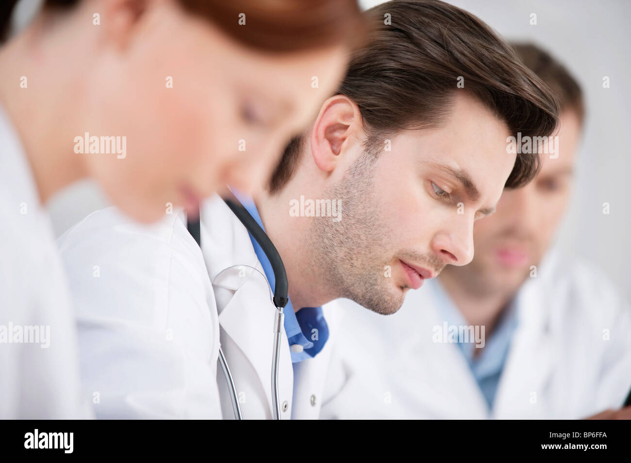 Three doctors working in an office Stock Photo - Alamy