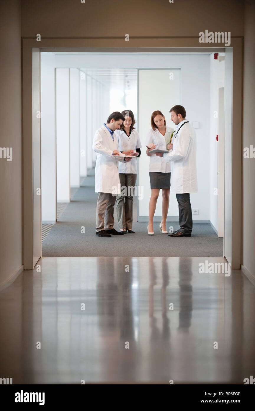 Four doctors examining medical reports Stock Photo - Alamy