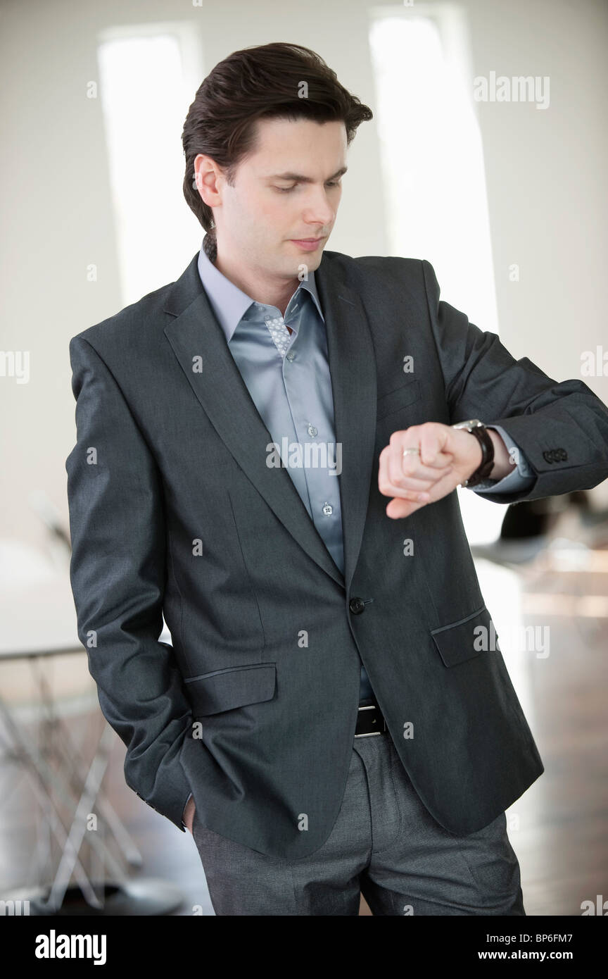 Businessman checking the time Stock Photo - Alamy