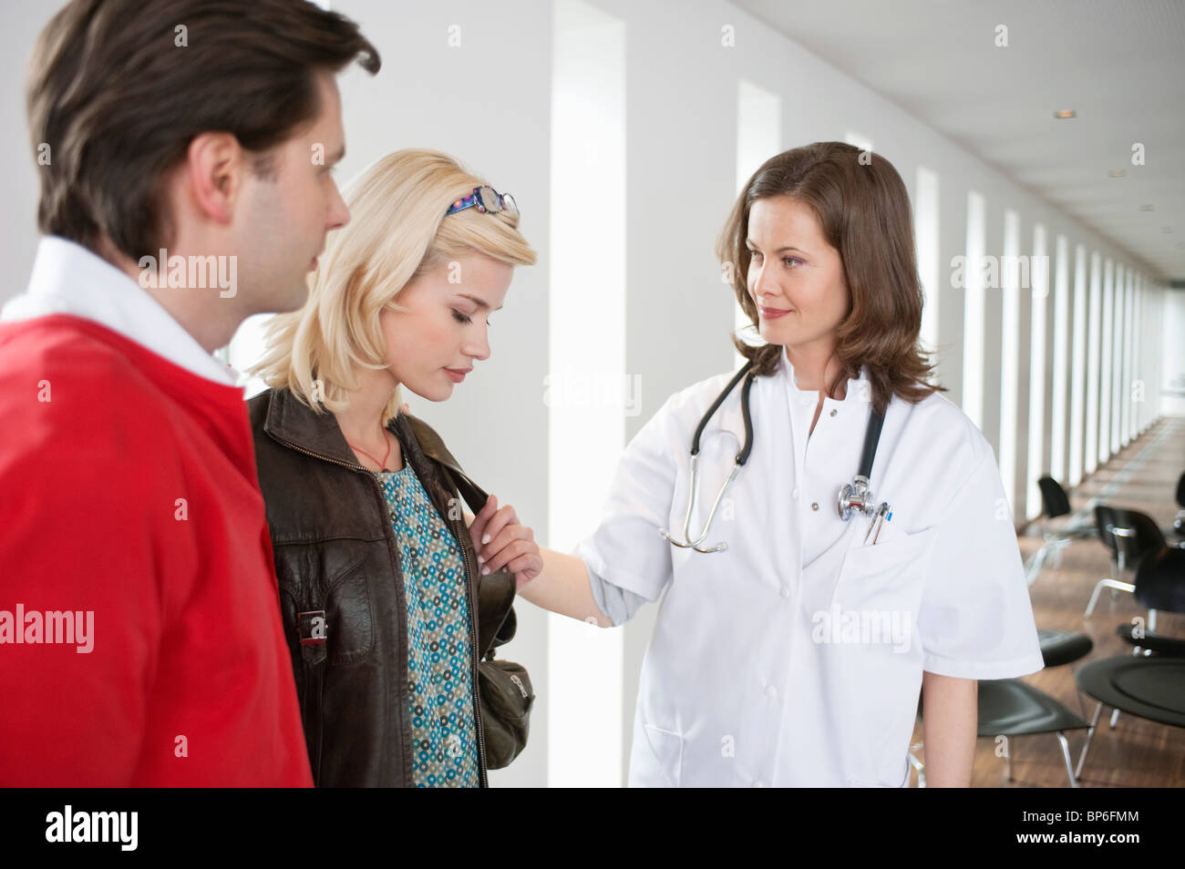 Female doctor consoling a patient Stock Photo - Alamy