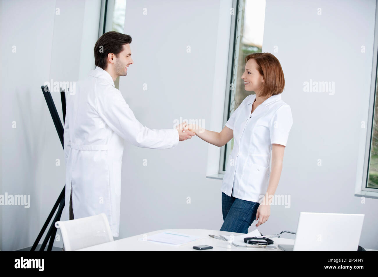 Two doctors shaking hands Stock Photo - Alamy