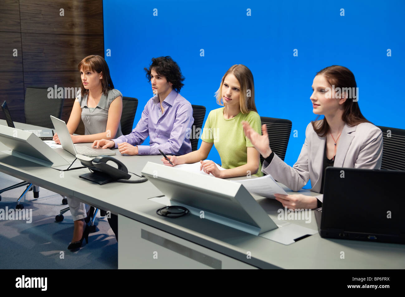 Business executives working in a control room Stock Photo - Alamy