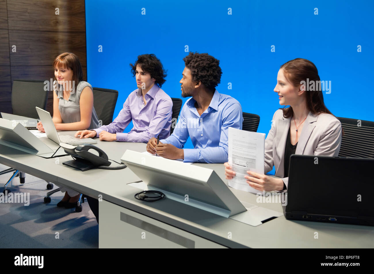 Business executives working in a control room Stock Photo - Alamy