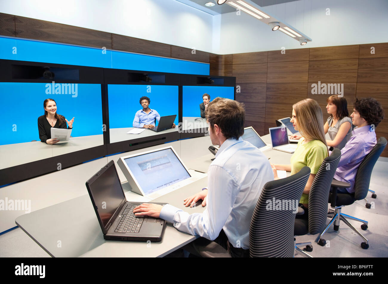 Business executives working in a control room Stock Photo - Alamy