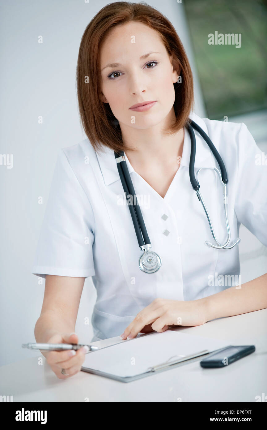 Female doctor working in an office Stock Photo - Alamy