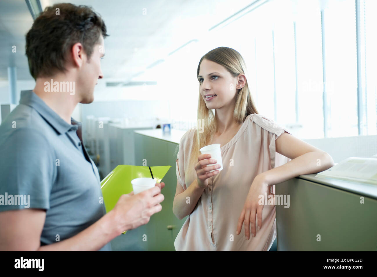 Business executives in an office during a coffee break Stock Photo - Alamy