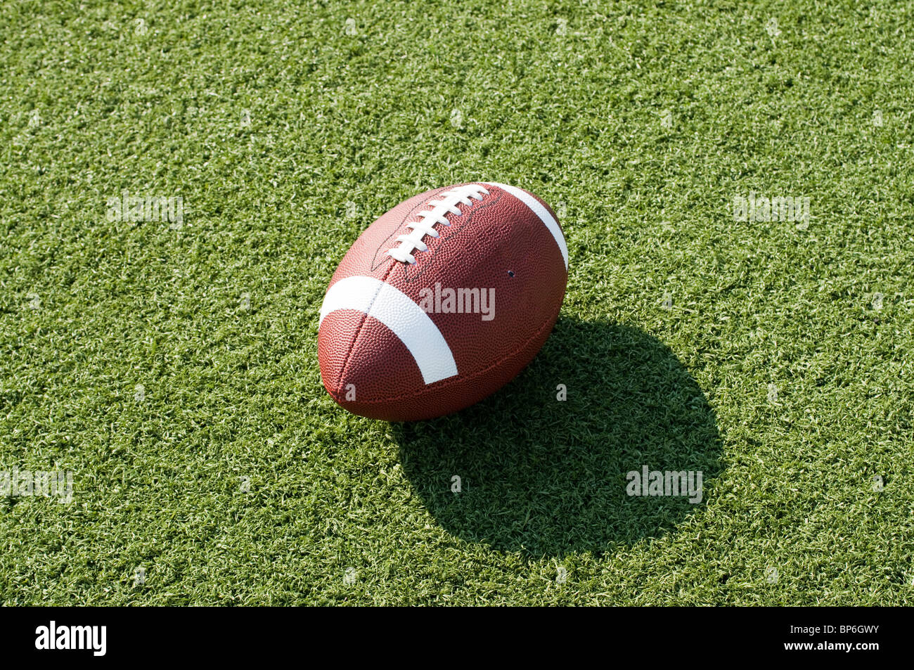 American football on field with afternoon shadow Stock Photo - Alamy