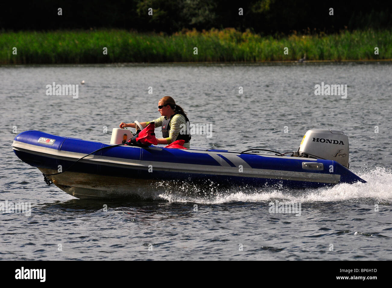 woman driving a speed boat on lake Stock Photo - Alamy