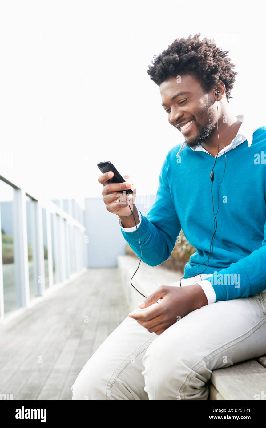 Man listening to an MP3 player Stock Photo - Alamy