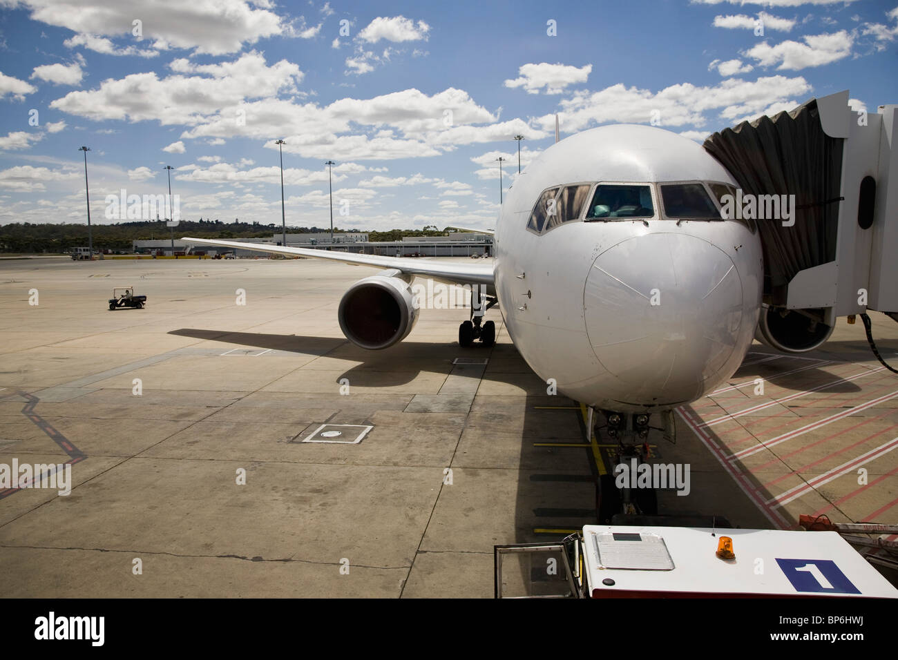 An airplane connected to a passenger boarding bridge Stock Photo - Alamy