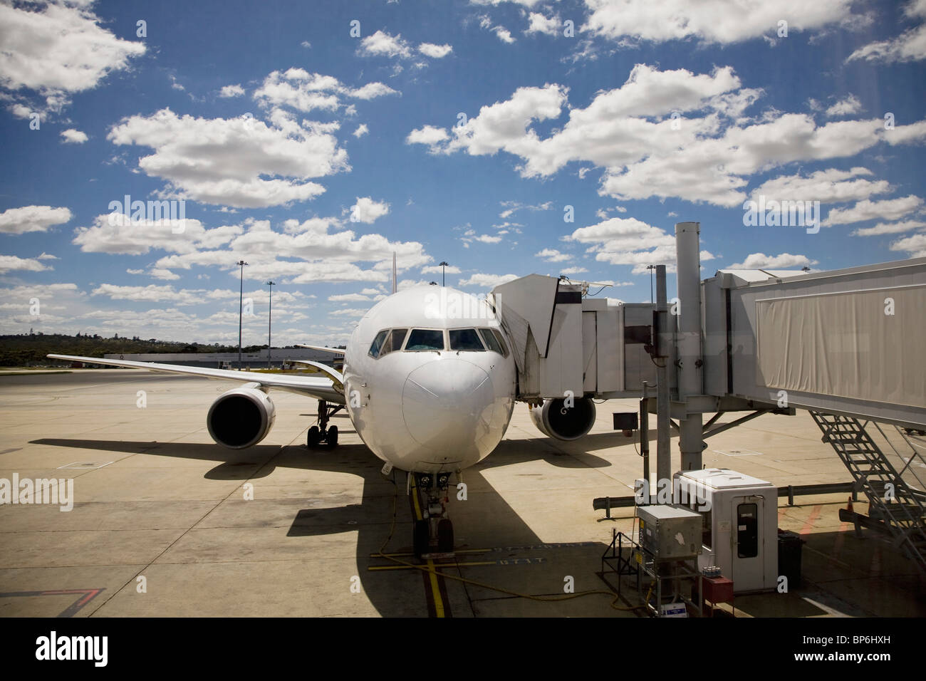 An airplane connected to a passenger boarding bridge Stock Photo - Alamy