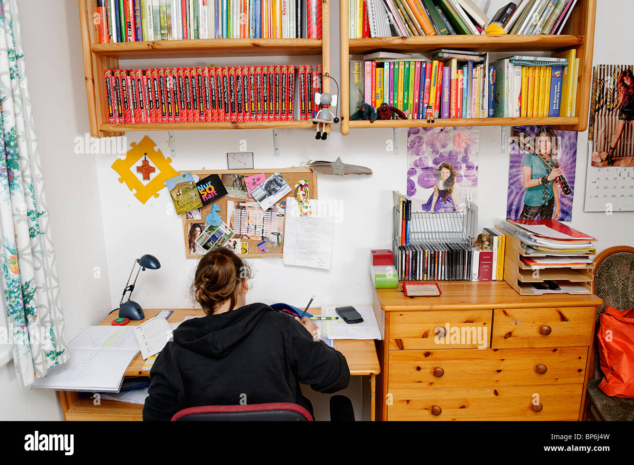 young girl doing her homework seen from the back Stock Photo - Alamy