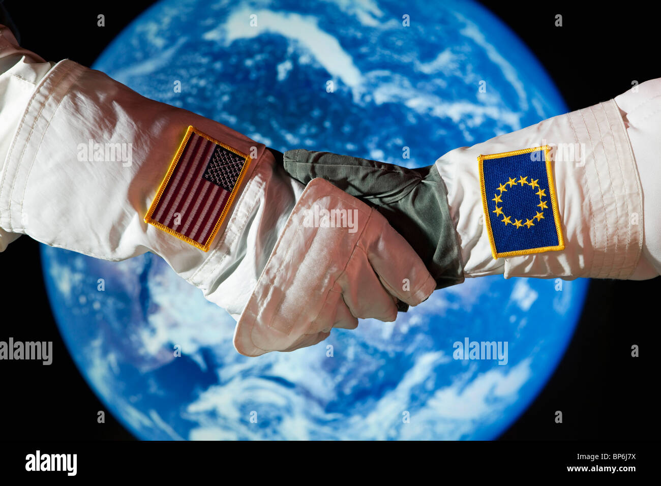 An American astronaut shaking hands with an astronaut from the European ...
