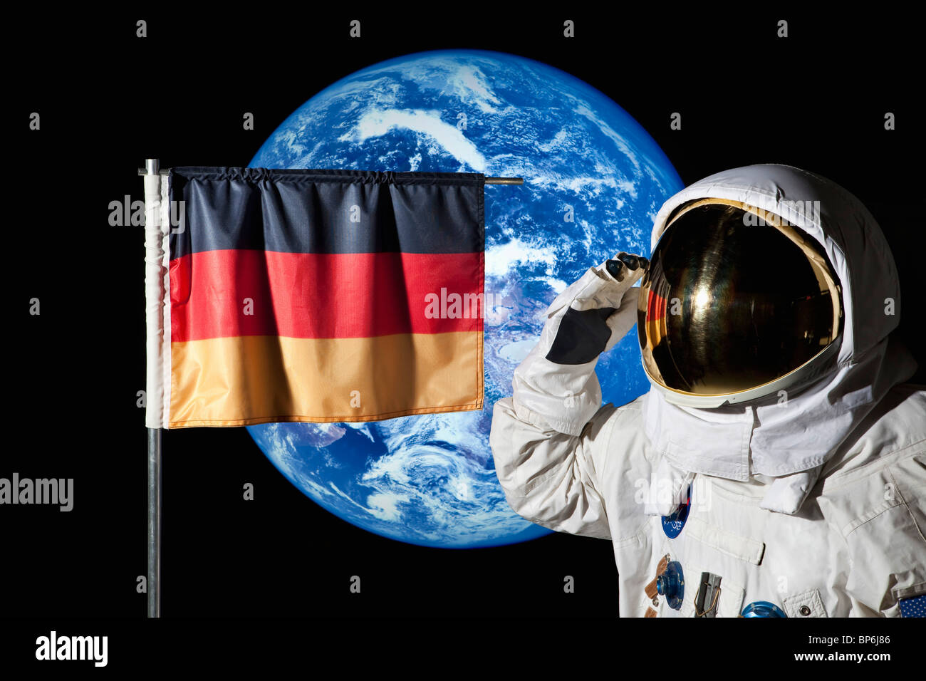 An astronaut saluting an German flag with the earth in the background ...