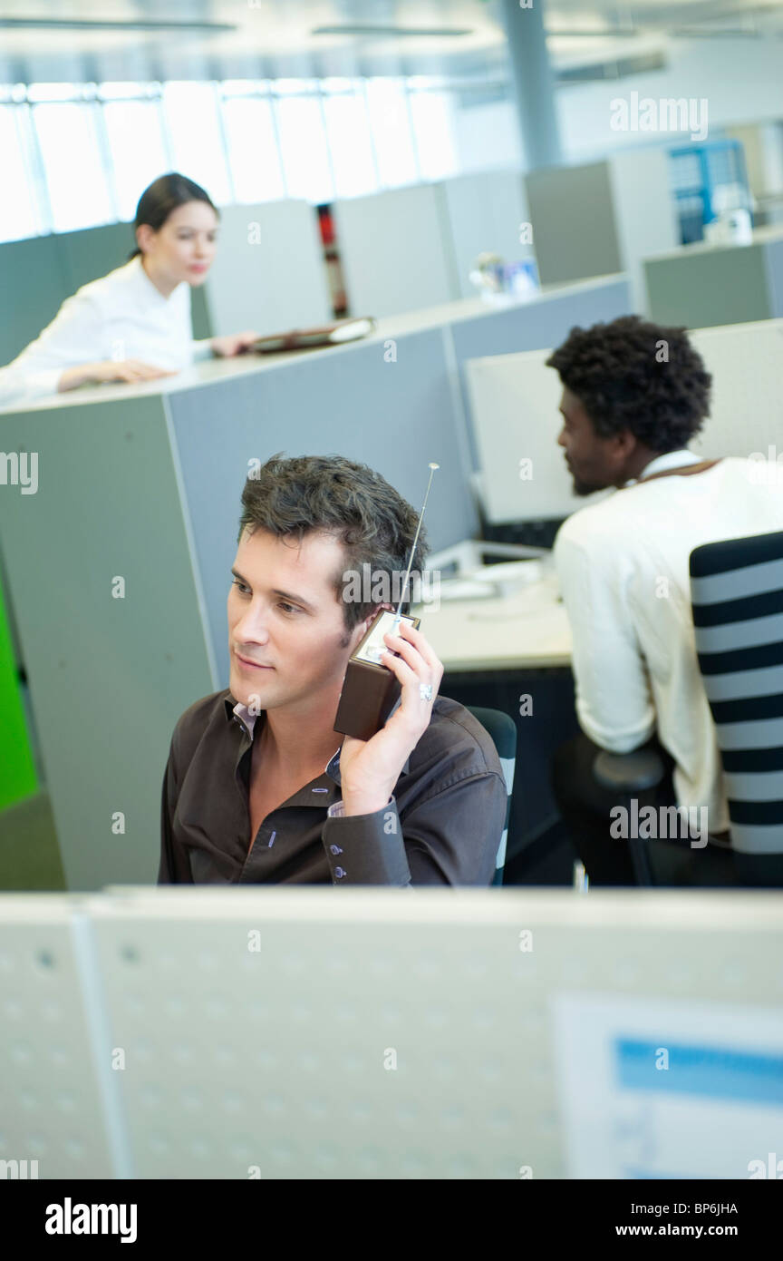 Businessmen listening to a radio in an office Stock Photo - Alamy