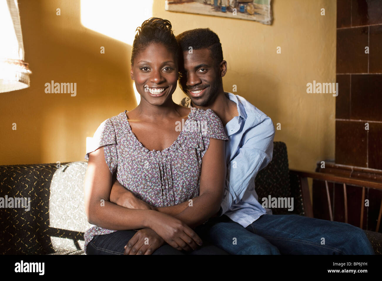 A young couple relaxing on a couch, portrait Stock Photo - Alamy