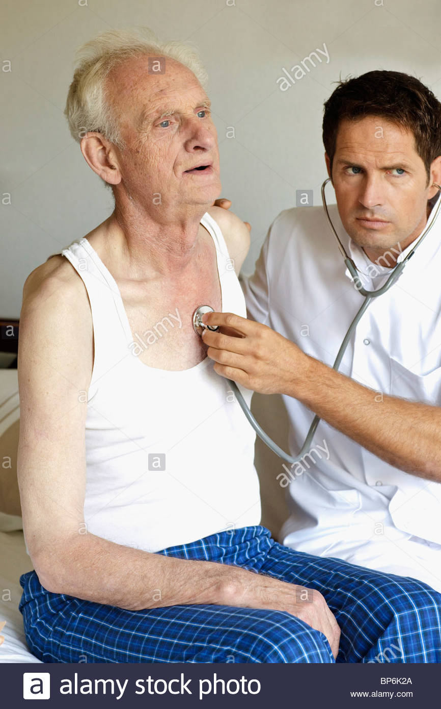 A Doctor With Stethoscope Examining Heart Stock Photos & A Doctor With ...