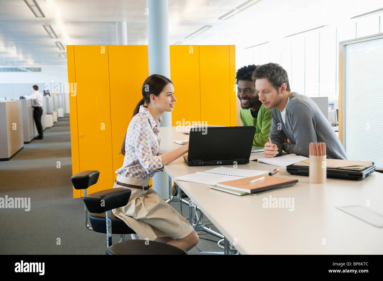 Business executives using laptops in an office Stock Photo - Alamy