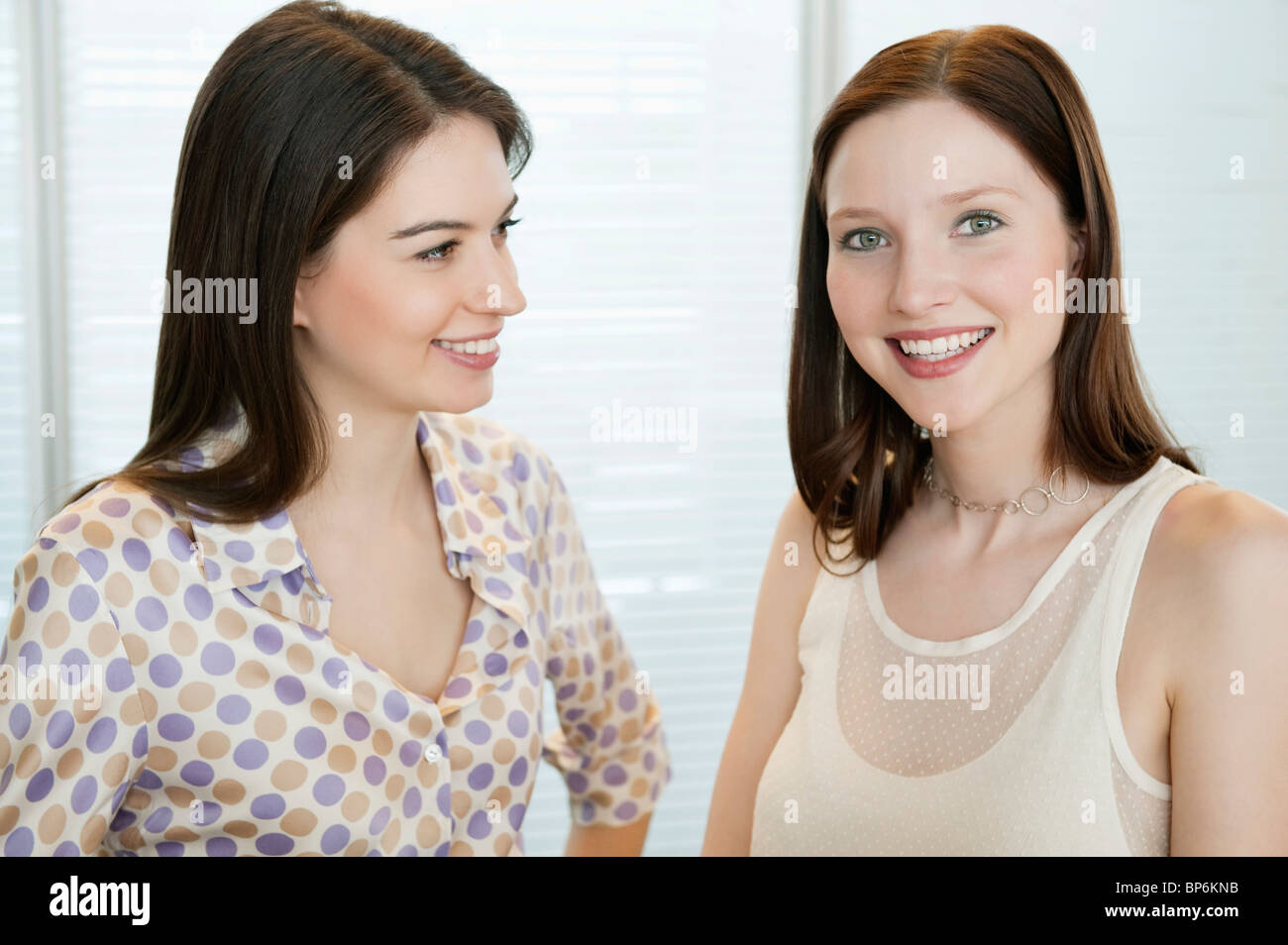 Businesswomen smiling in an office Stock Photo - Alamy