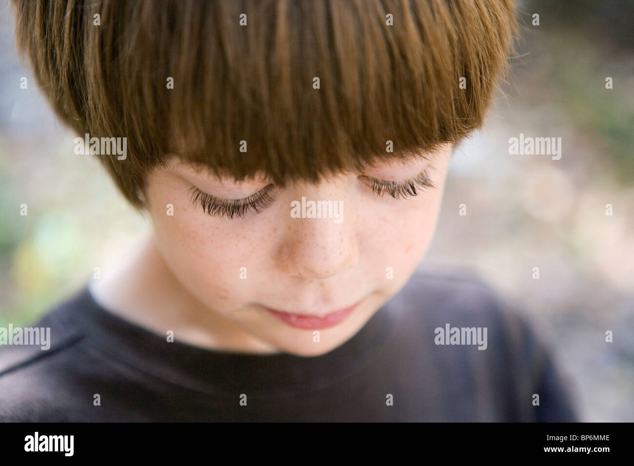 Portrait of a boy looking down Stock Photo - Alamy
