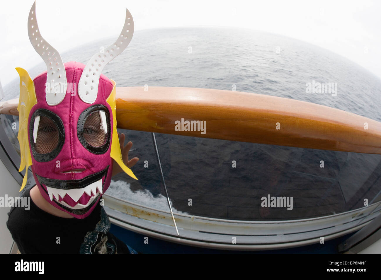 A boy wearing a mask on a boat Stock Photo - Alamy