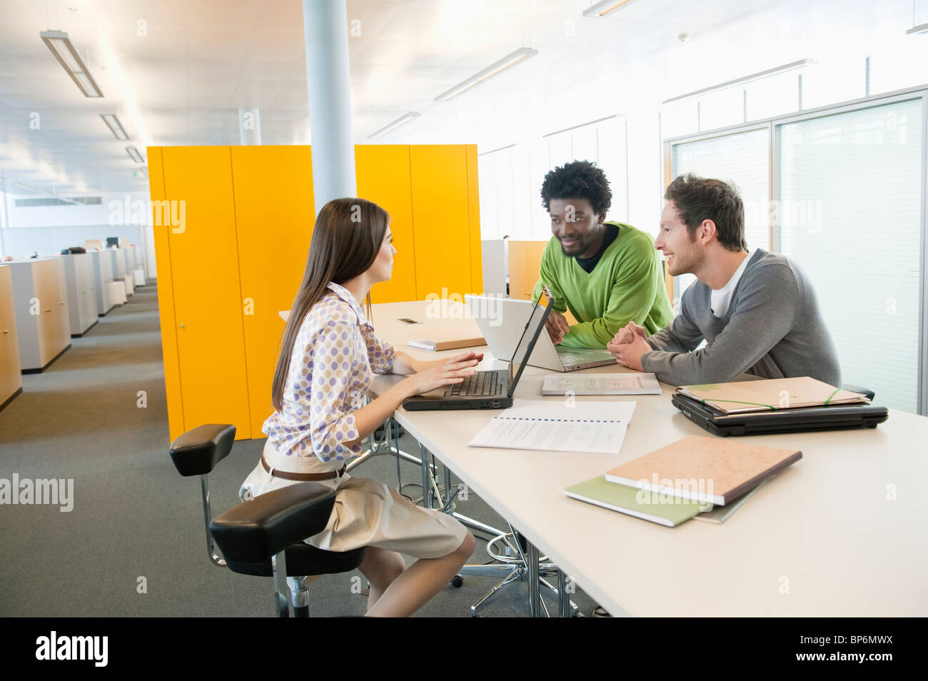 Business executives using laptops in an office Stock Photo - Alamy