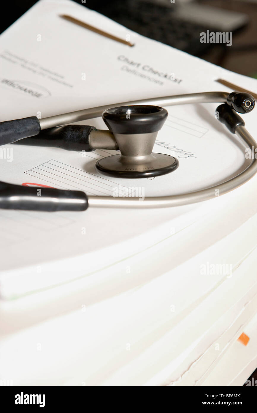 A stethoscope on top of a stack of medical charts Stock Photo - Alamy