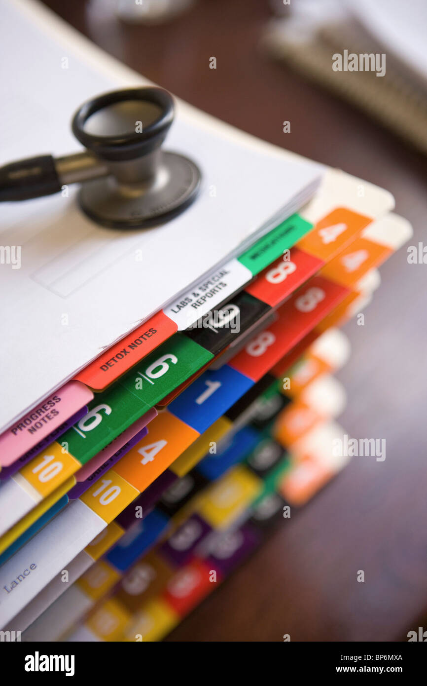 A stethoscope on top of a stack of patient files Stock Photo - Alamy