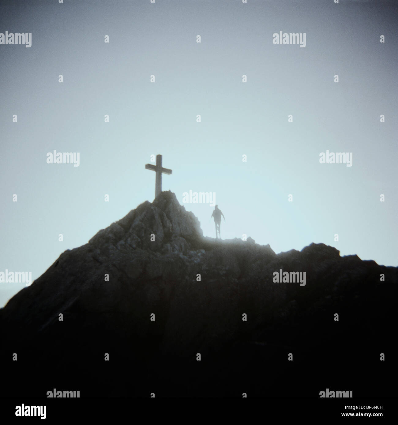 A person standing below a crucifix on a mountain top, Mount Saint ...