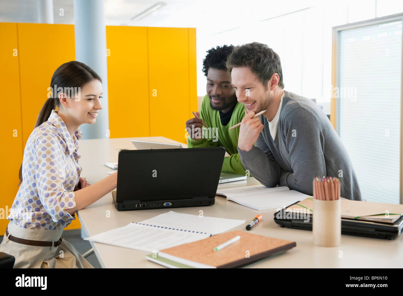 Business executives using laptops in an office Stock Photo - Alamy