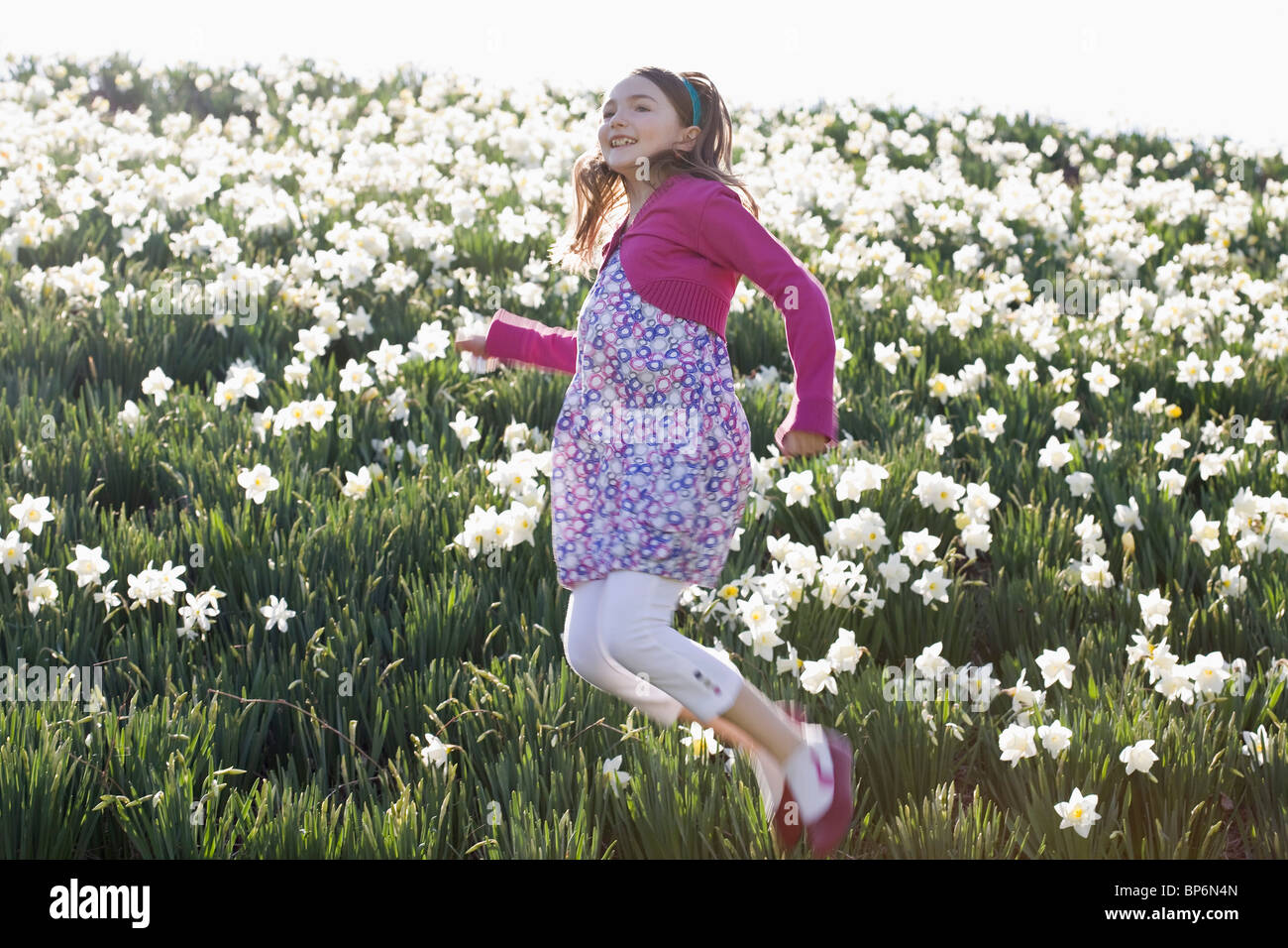 Girl jumping in field flowers hi-res stock photography and images - Alamy